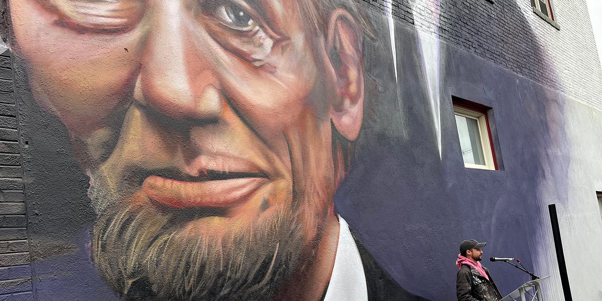 Final touches on latest Main Street mural - by Dave Bangert
