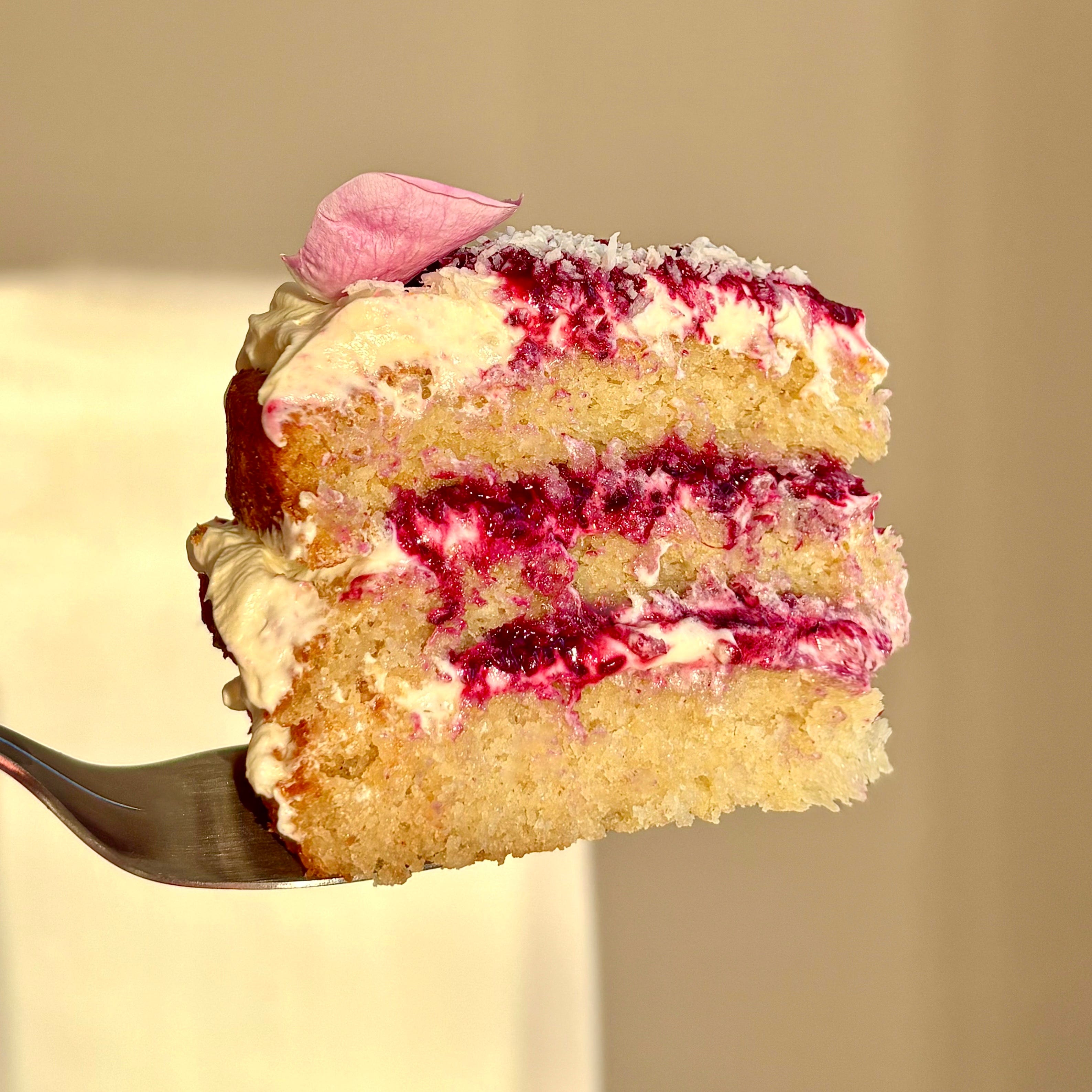 Coconut Sponge, Coconut Cream, Raspberry, Rose and Blackberry Filling.