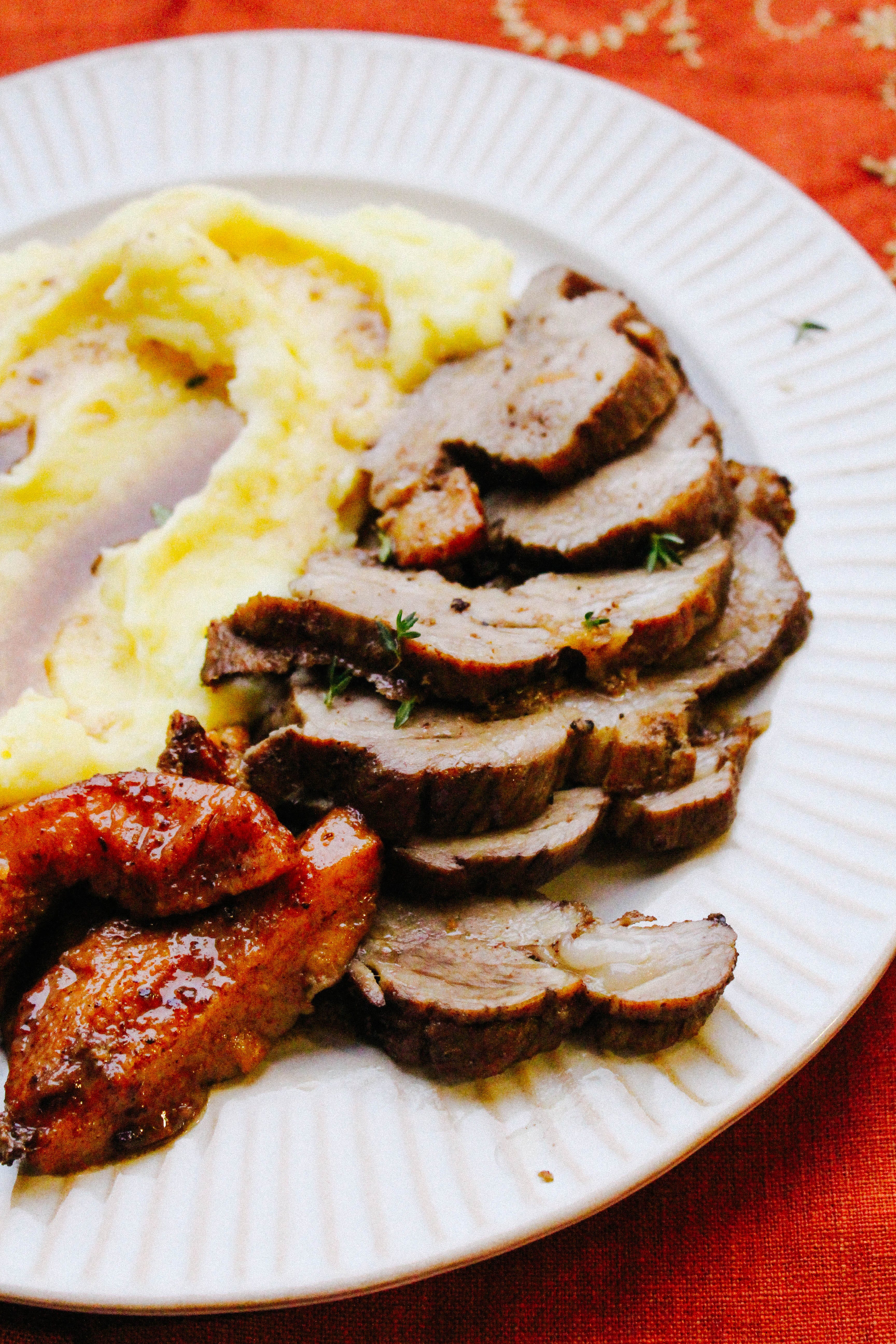 Oven roasted pork neck roulade with quinces and date syrup