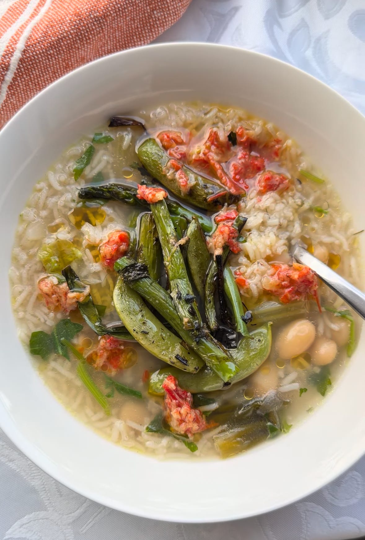 Aromatic vegetable broth, grilled greens, rice, white beans, and a ...