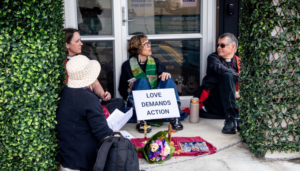 Priests chain themselves to Erica Stanfords office in political stunt