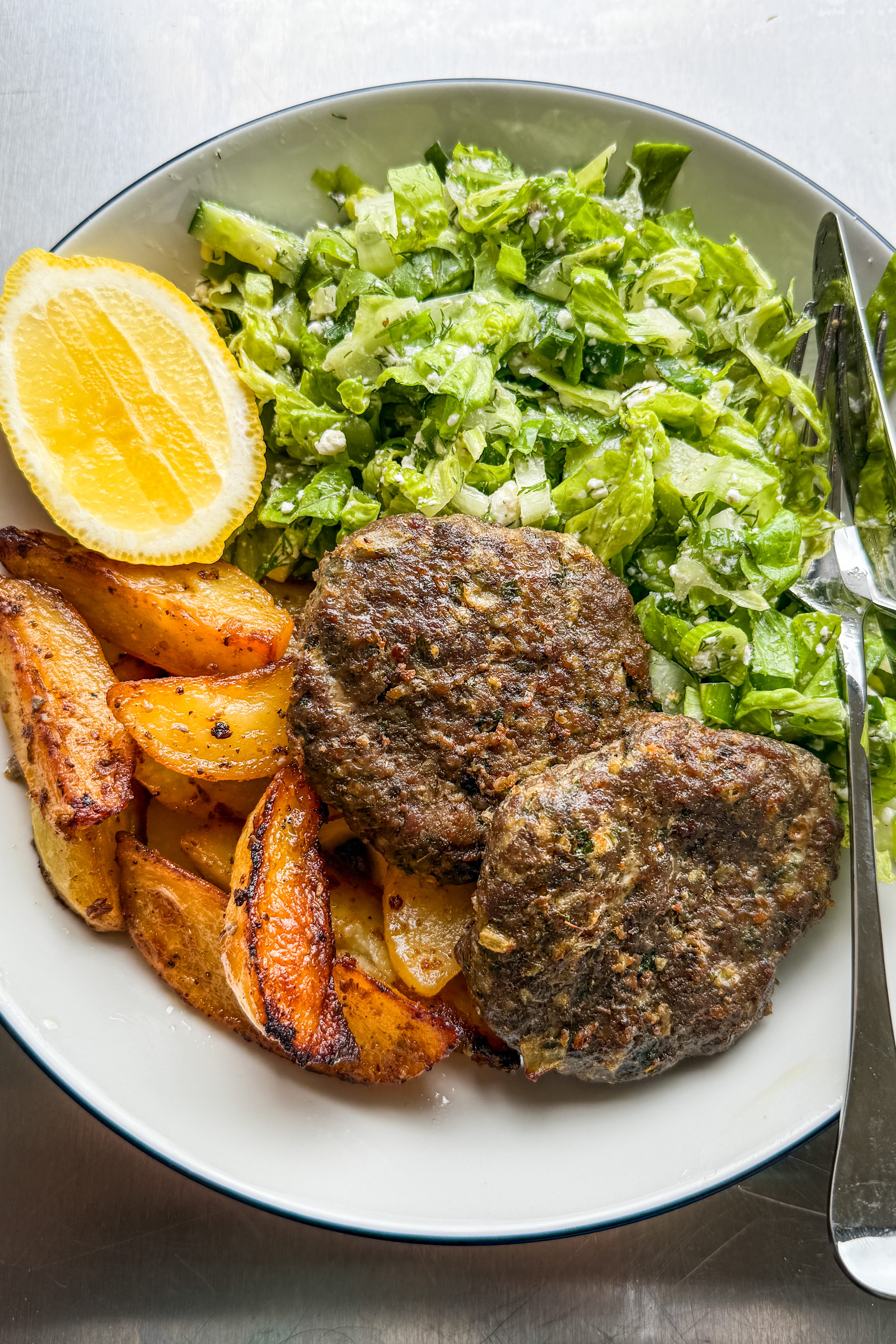 Greek Biftekia with Lemon Roasted Potatoes and Maroulosalata