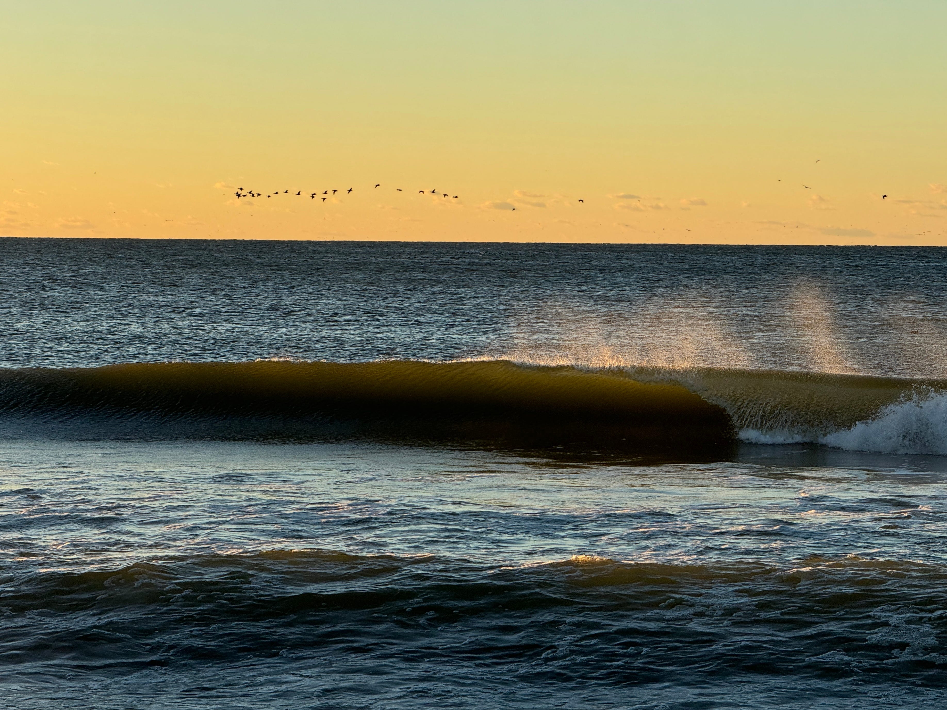 Here's a photo of a blue wave at sunrise