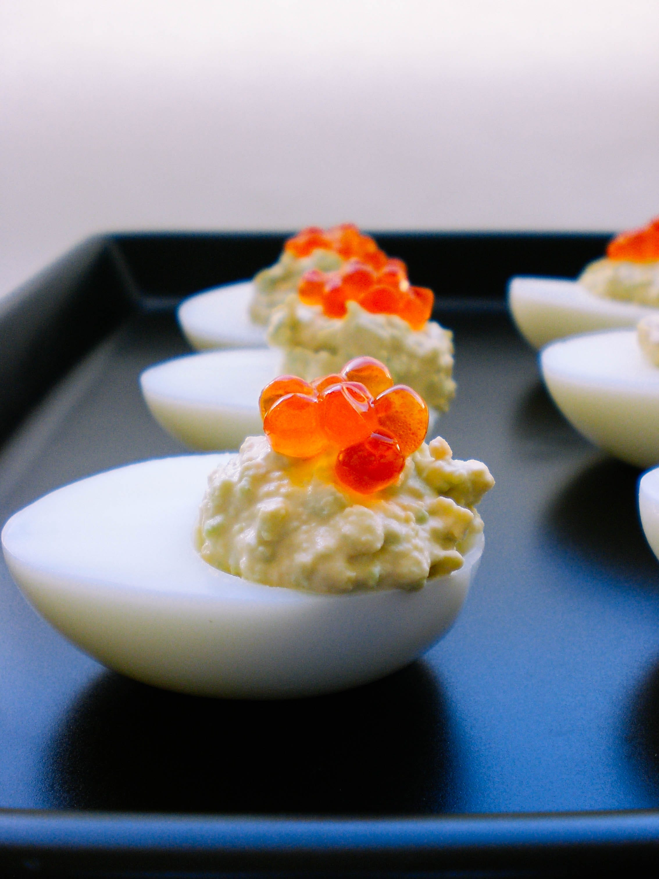 Deviled eggs with avocado, crème fraîche and salmon roe