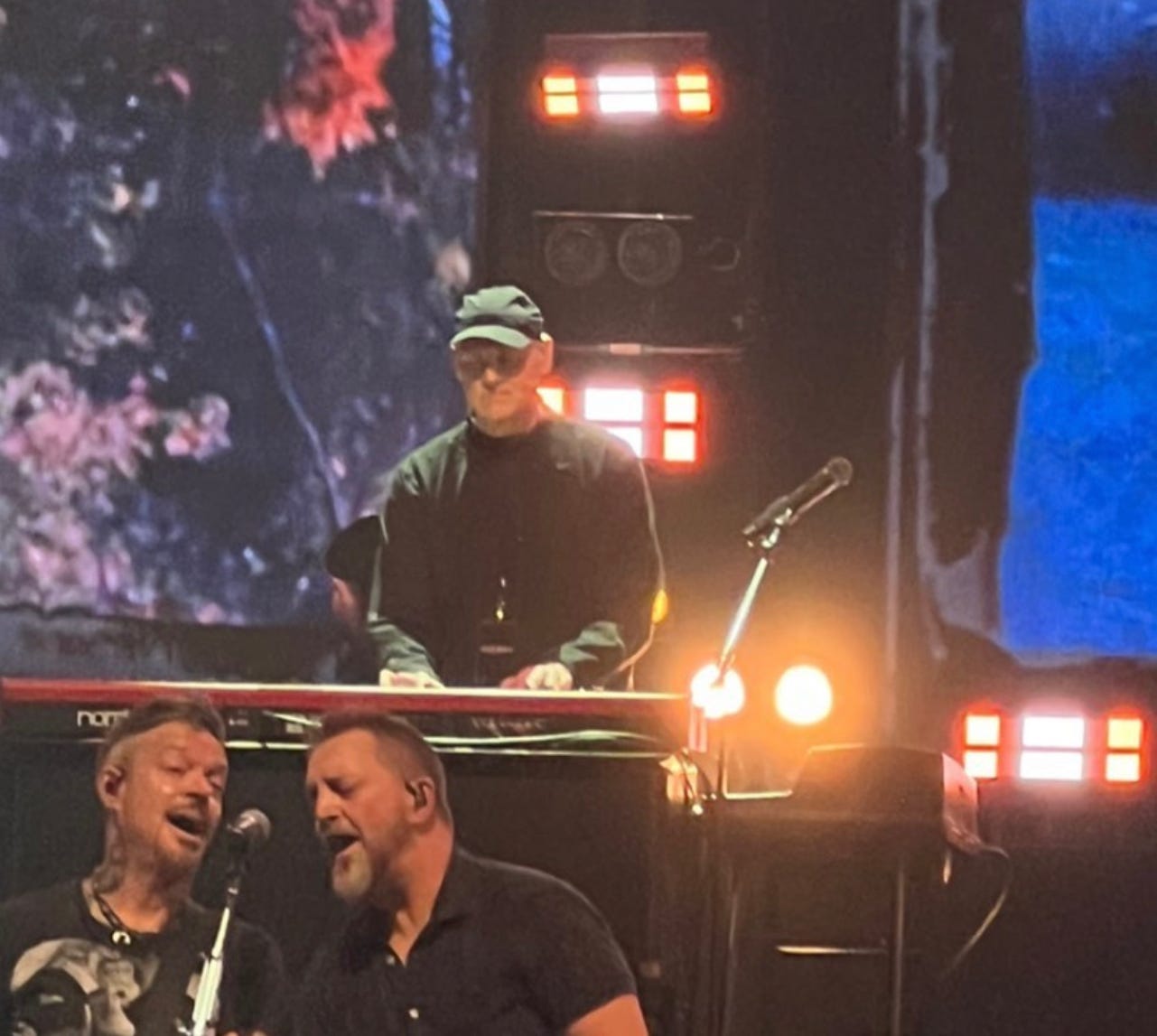 Rick Carlisle behind a piano, on stage with artists and dedicating a ...