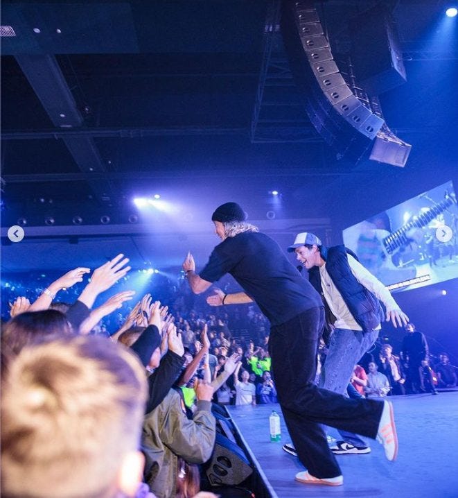 Hillsong Leader Phil Dooley Crowdsurfs During Worship Event