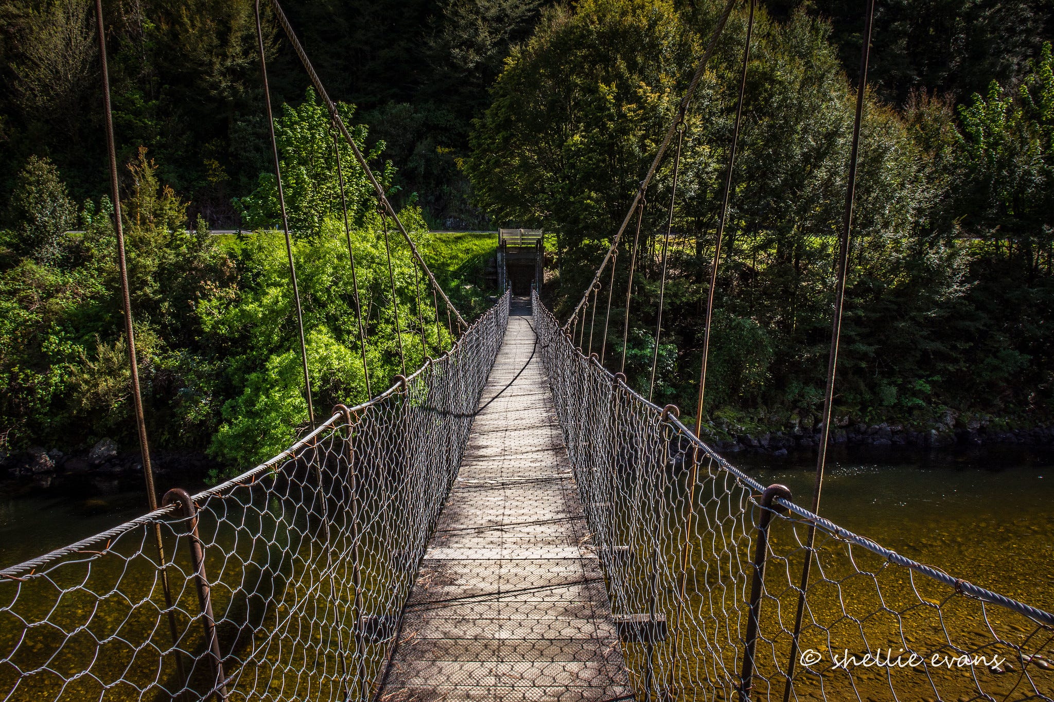 The infamous Inangahua River swing bridge, soaked in summer sun,