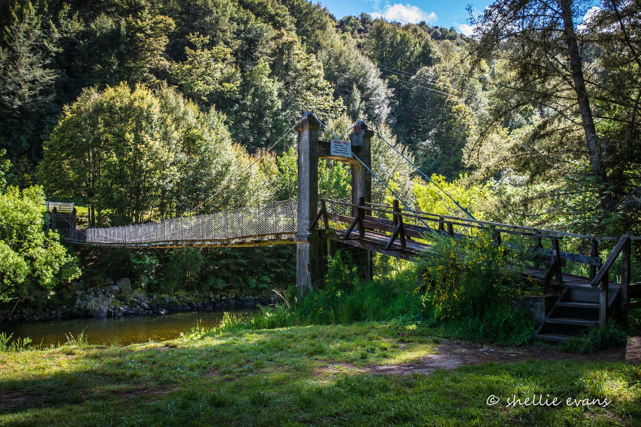 The infamous Inangahua River swing bridge, soaked in summer sun,