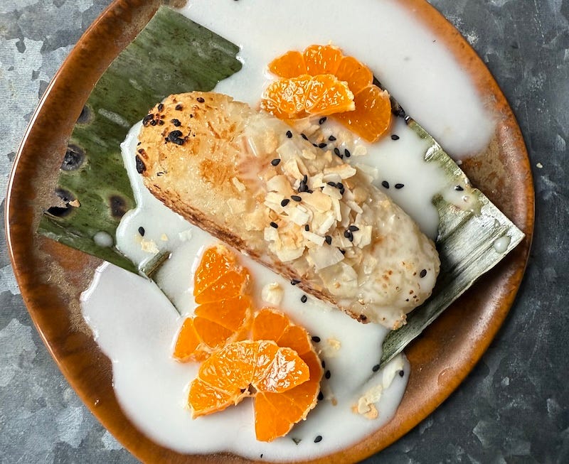 Grilled bananas in sticky rice with coconut sauce