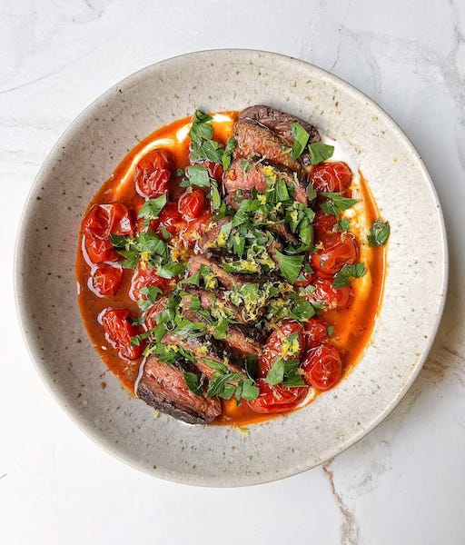 Steak with Harissa Tomato Confit over Lemon Garlic Yogurt
