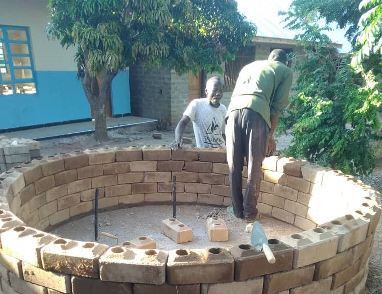 Addressing water and sanitation needs with soil-stabilized bricks