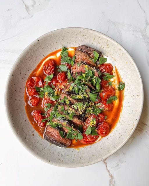 Steak with Harissa Tomato Confit over Lemon Garlic Yogurt