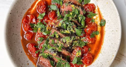 Steak with Harissa Tomato Confit over Lemon Garlic Yogurt